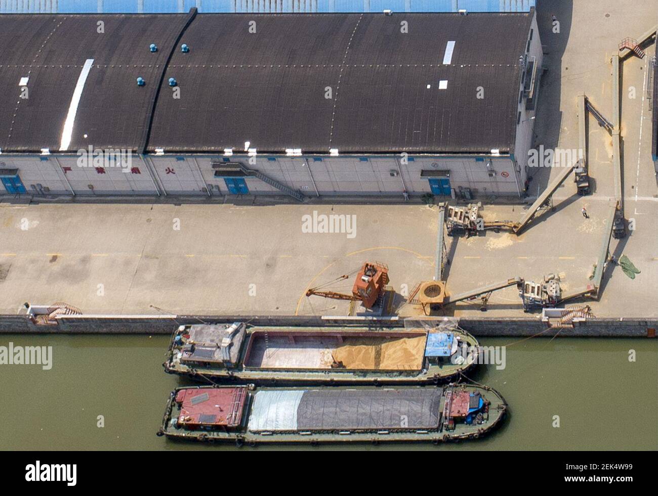 TAIZHOU, CHINA - JUNE 4, 2020 - Workers load and unload wheat at the ...
