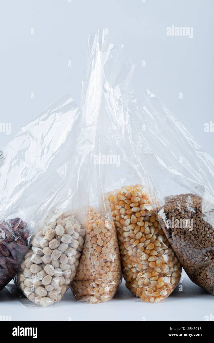 Different kinds of beans packed on a gray background Stock Photo - Alamy
