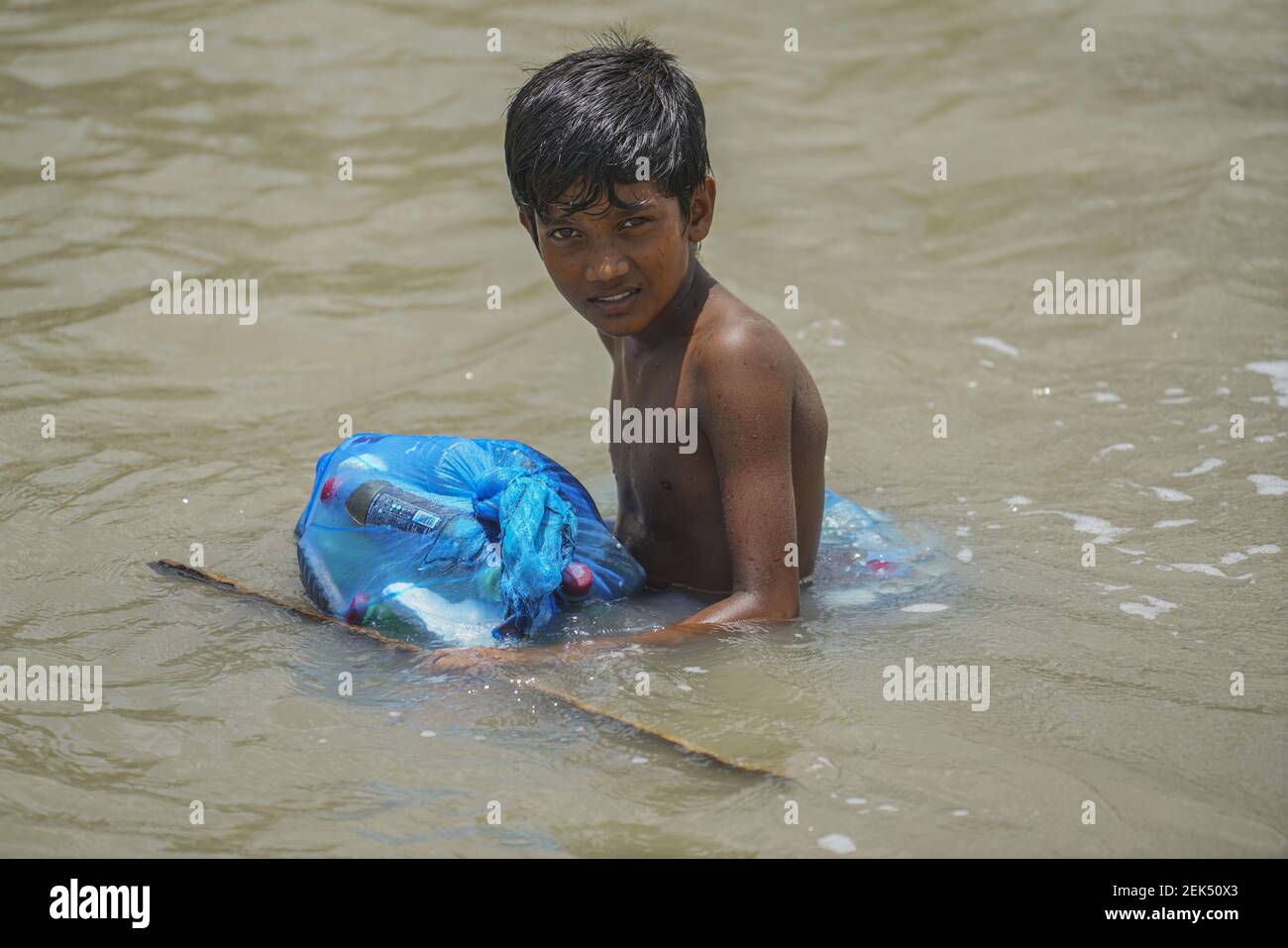 A boy seen floating with makeshift plastic boat after the landfall of ...