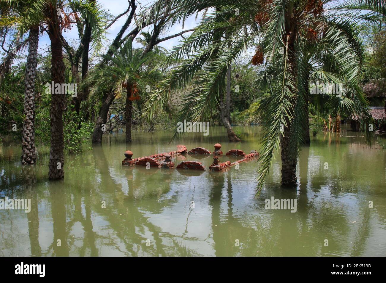 A family graveyard sunk in the water as the embankment of the coastal ...