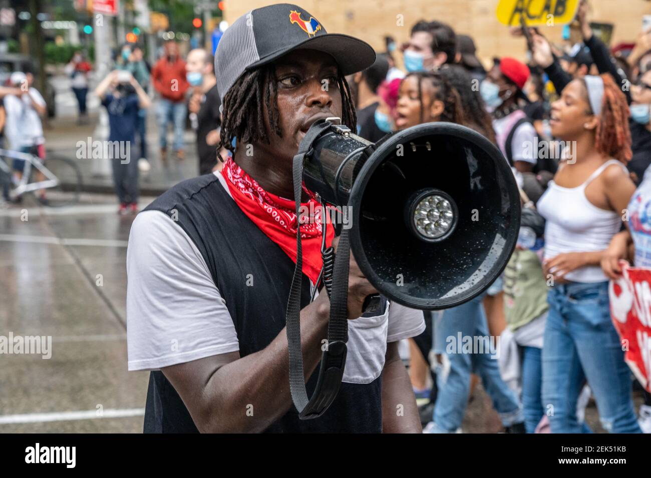 A protester shouts slogans on a megaphone during a peaceful ...