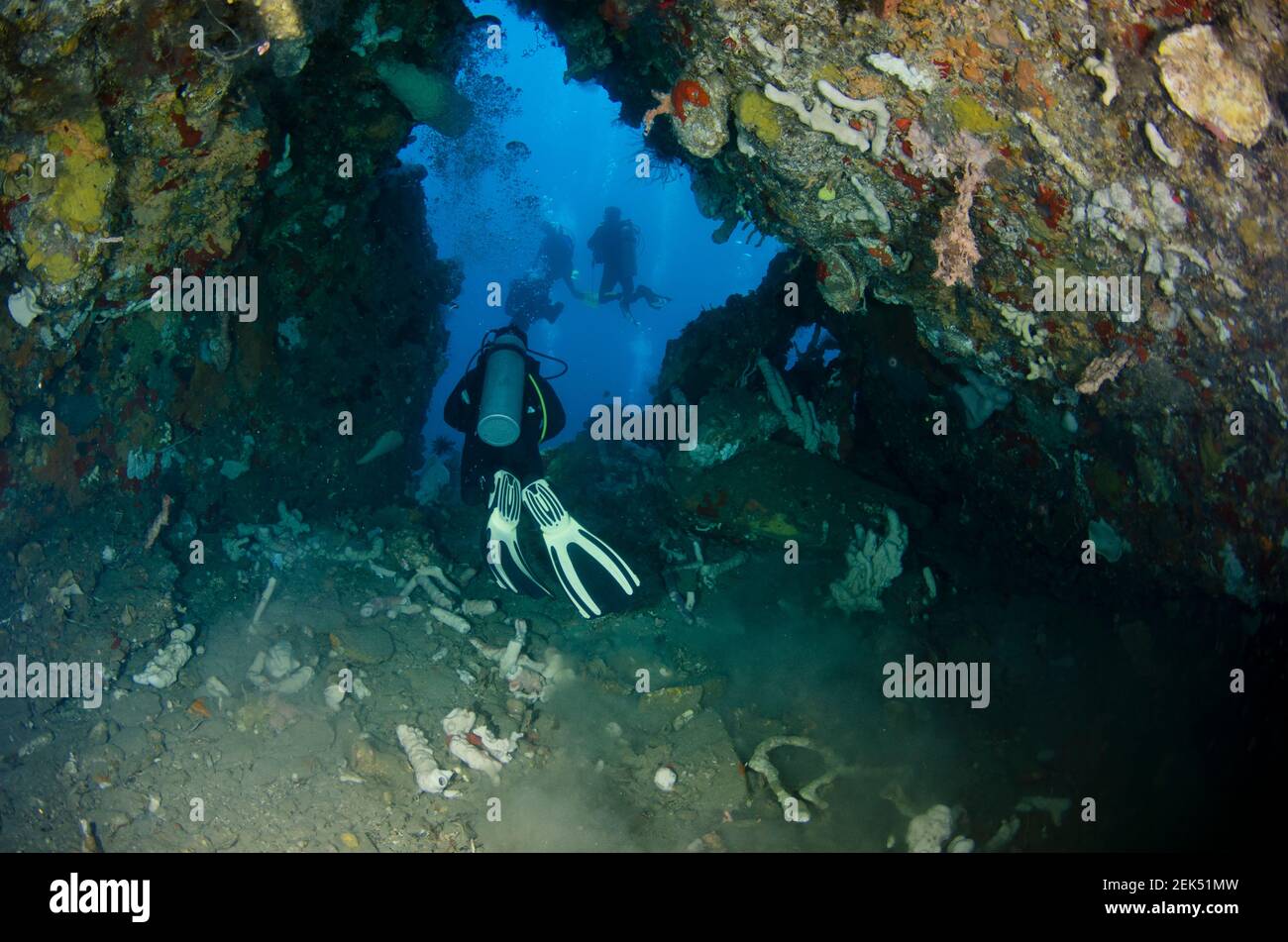 Divers exiting cave, The Cove dive site, Atauro Island, East Timor ...