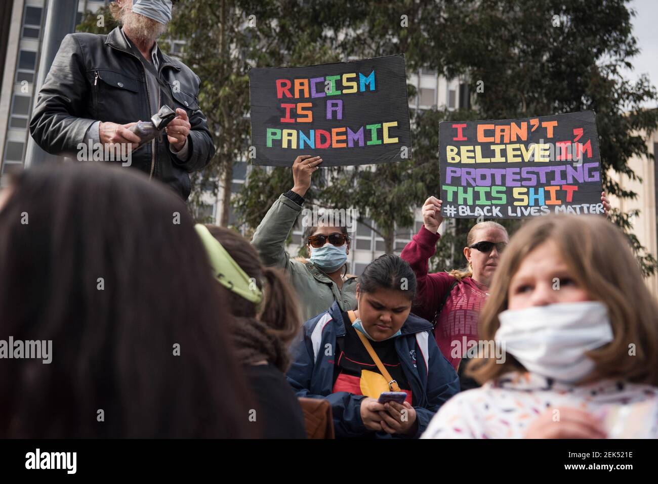 (EDITORS NOTE: Image contains profanity) Protesters hold placards ...