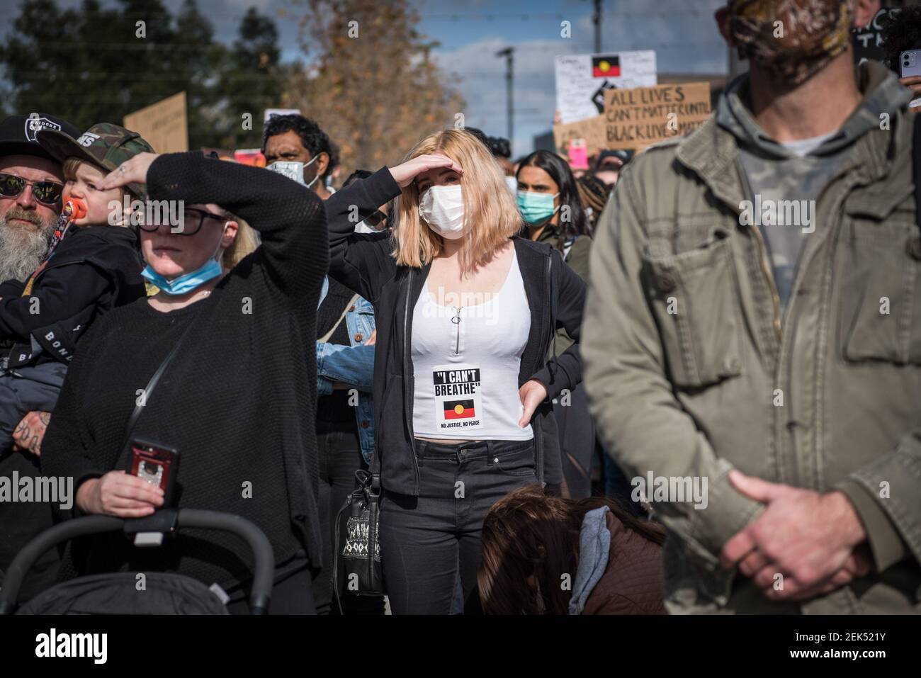 Protesters look on while wearing face masks during the demonstration ...
