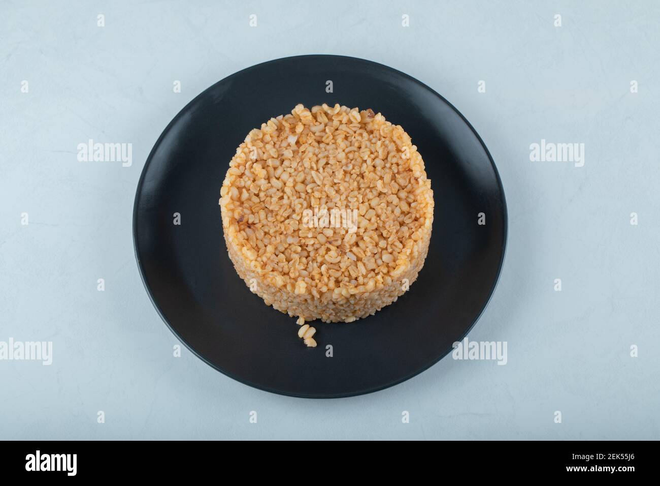 Turkish food bulgur rice on dark plate on a white background Stock ...