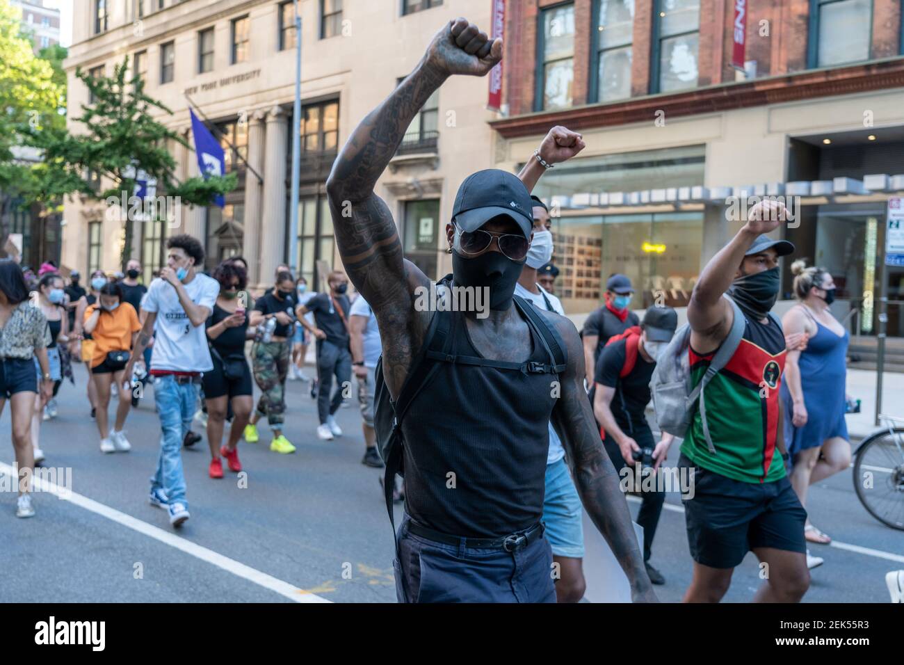Protesters hold up their fists during a peaceful demonstration ...