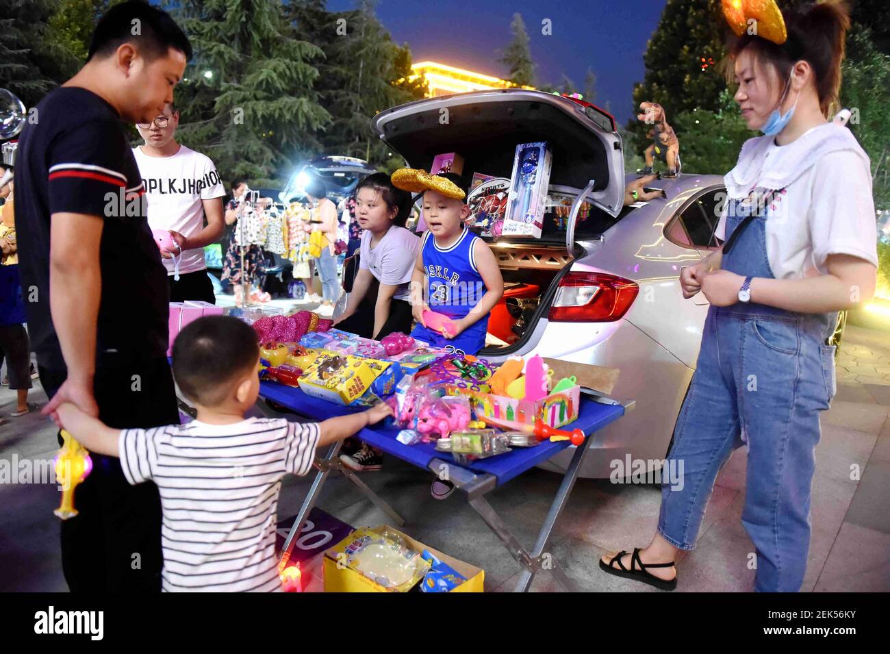 Customers wander and purchase at a trunk bazaar, where limousines ...