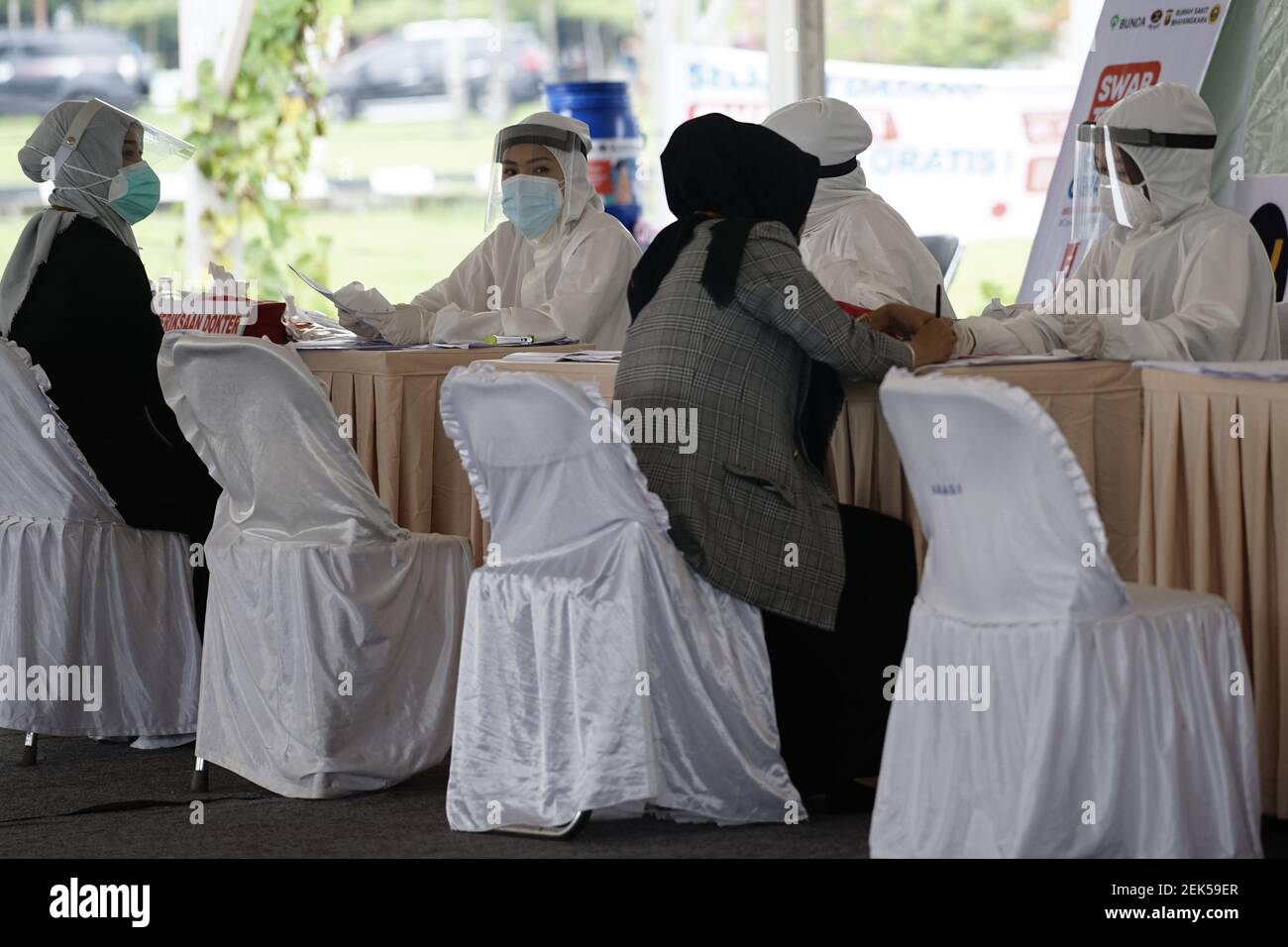 Health workers who wear personal protective equipment take a simple ...