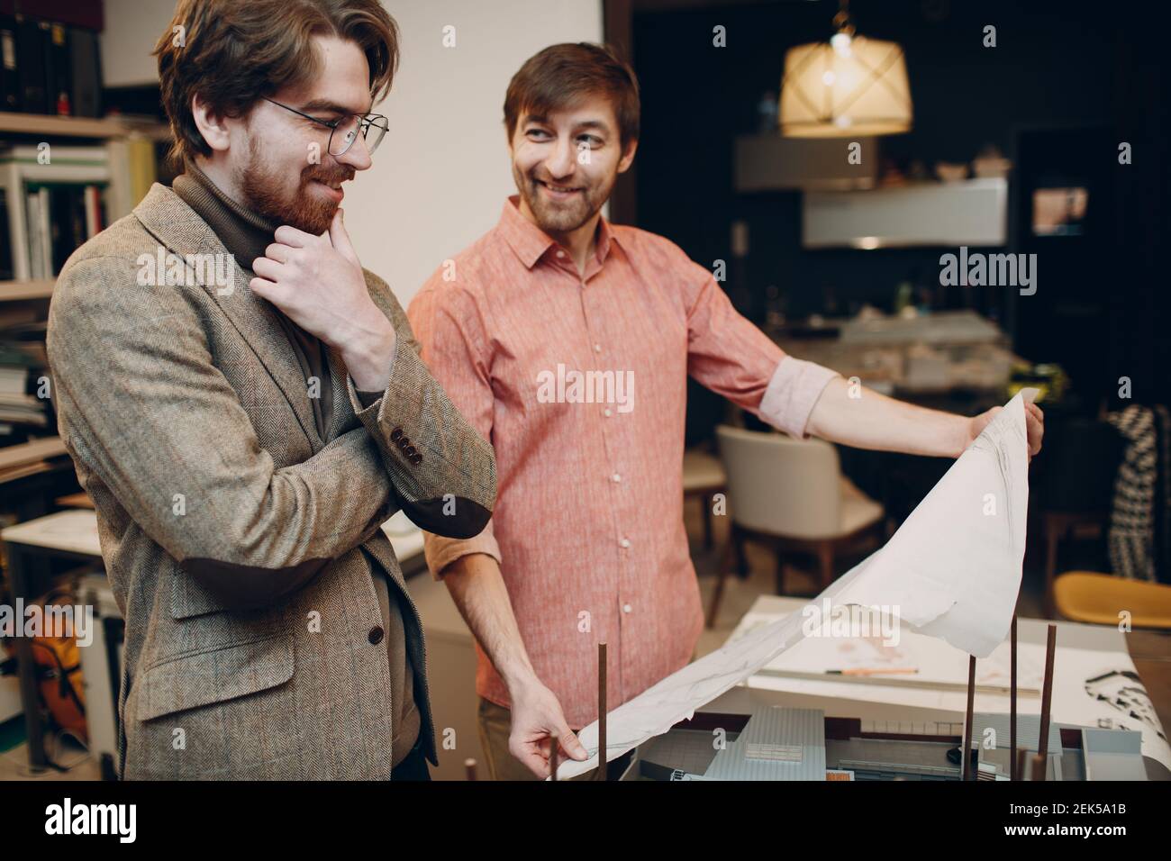 Architect with blueprints and layout design project at office bureau ...