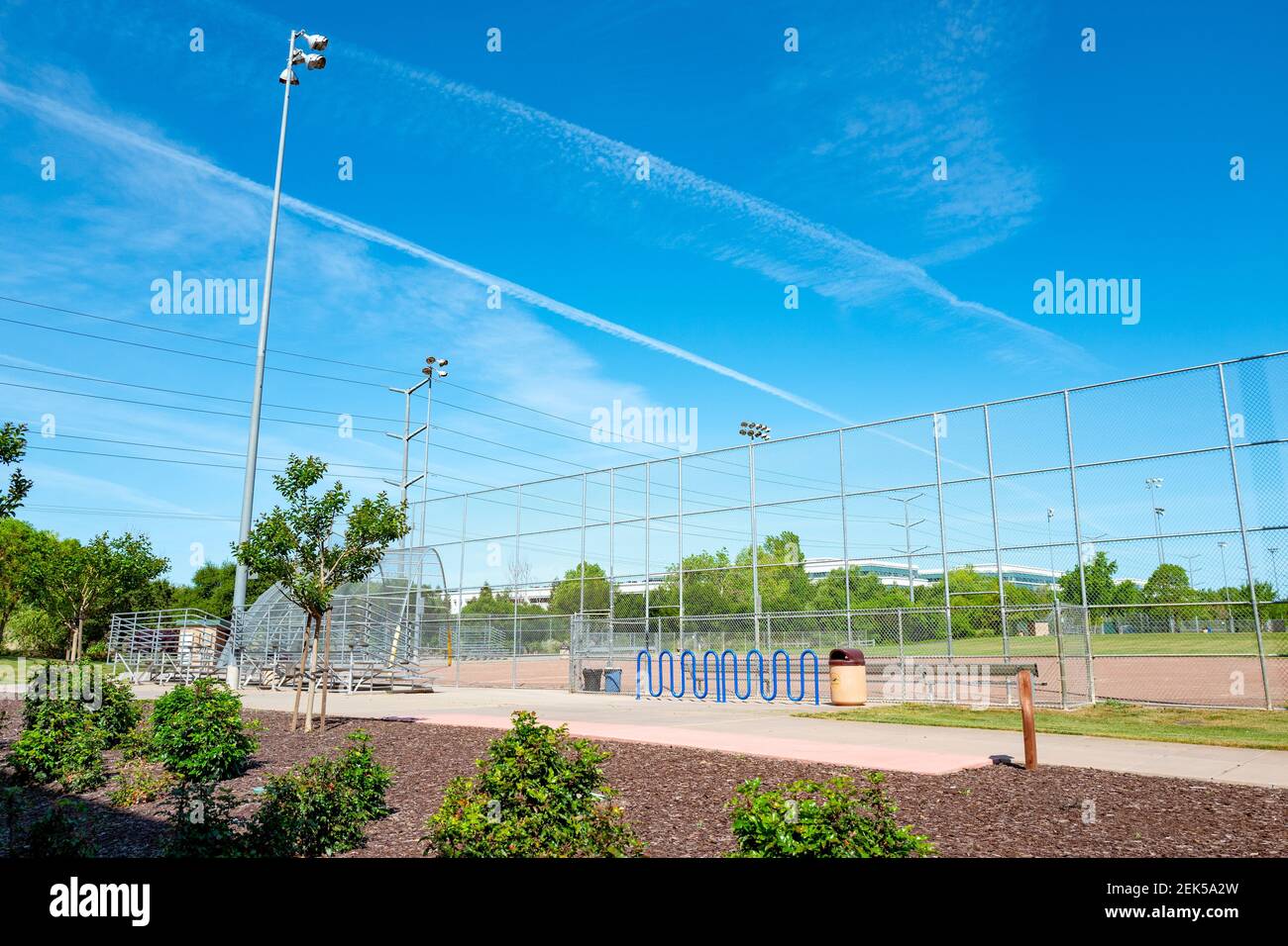 Airplane contrail is visible above a public park in San Ramon ...