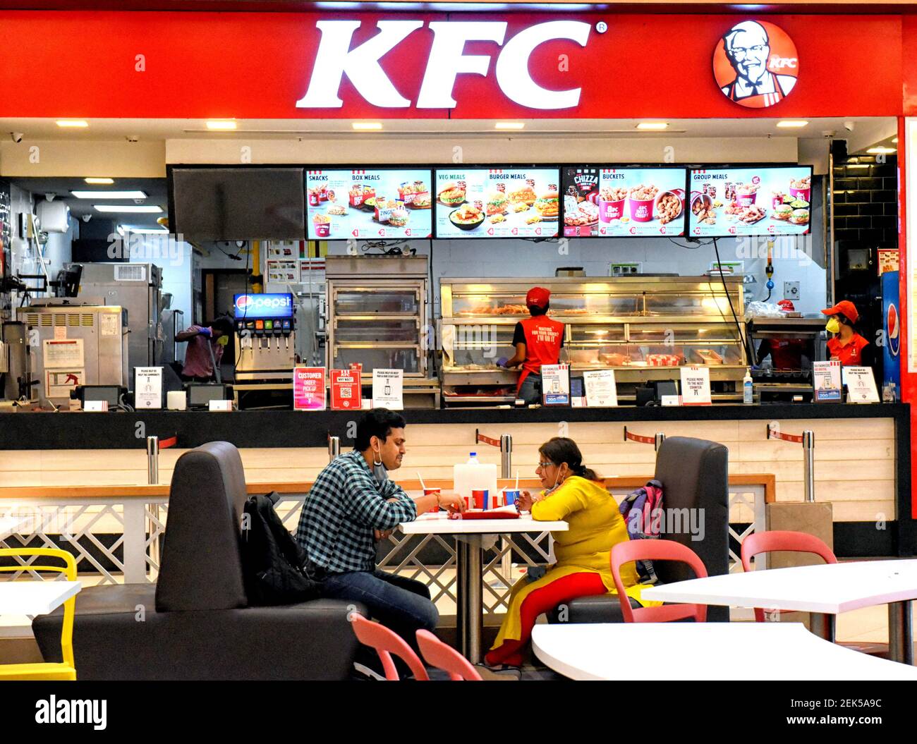 A couple seen taking lunch infront of a KFC store at South City Mall ...