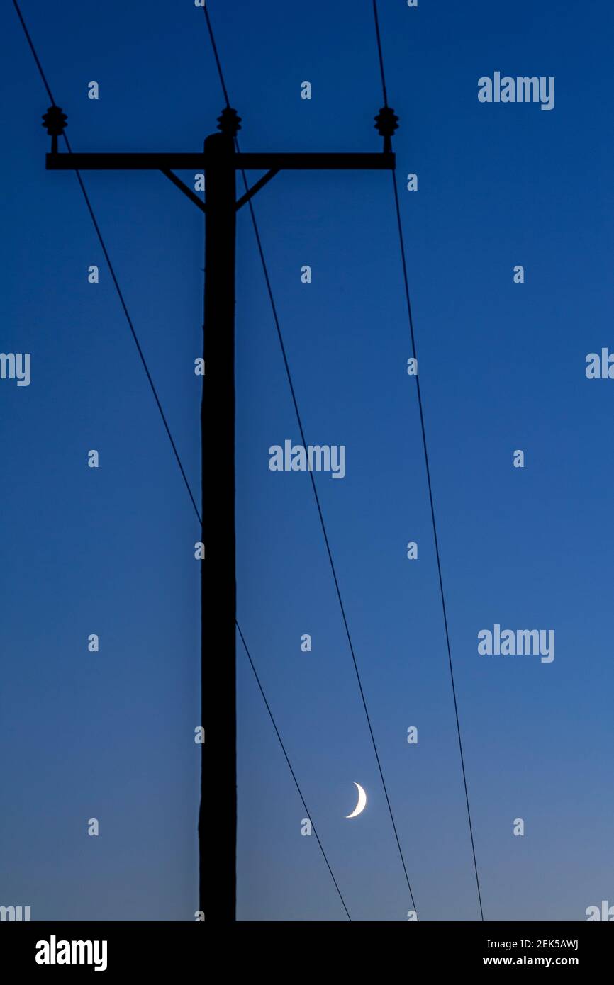 Crescent moon and telegraph pole at dusk Stock Photo - Alamy