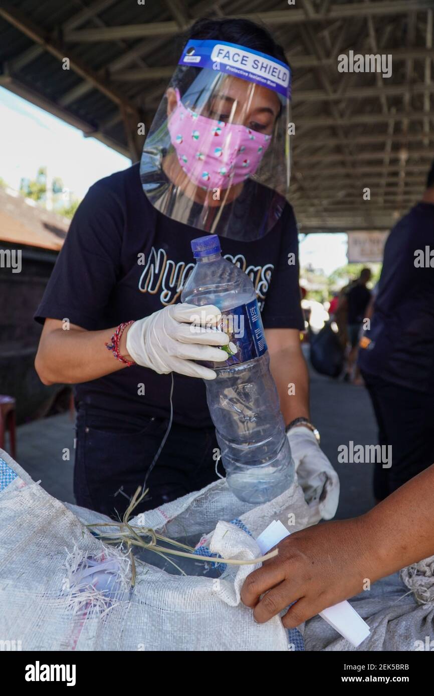 A volunteer organises plastic waste from villagers during the covid 19 ...