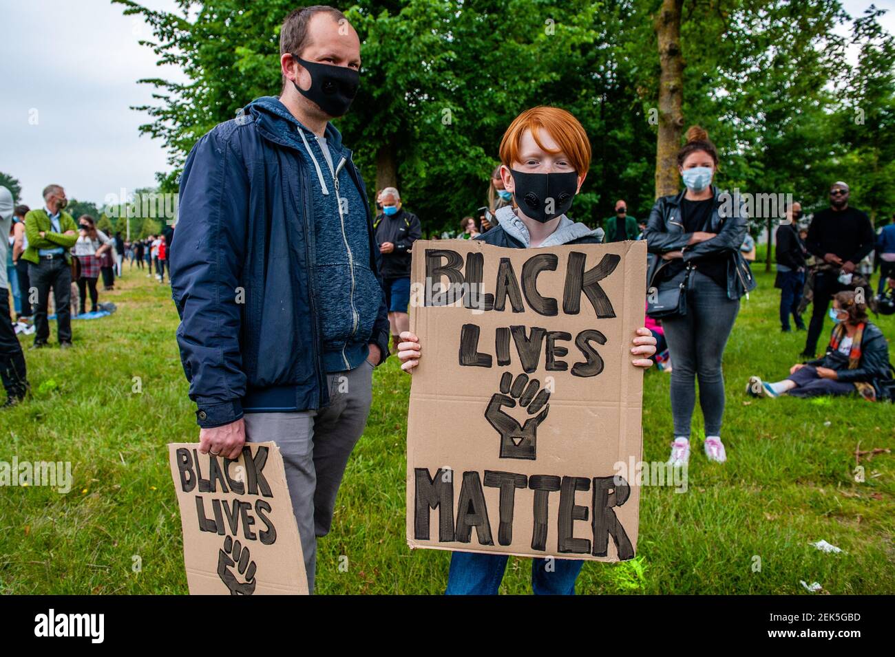 A father and a son are holding anti racist placards, during the second ...