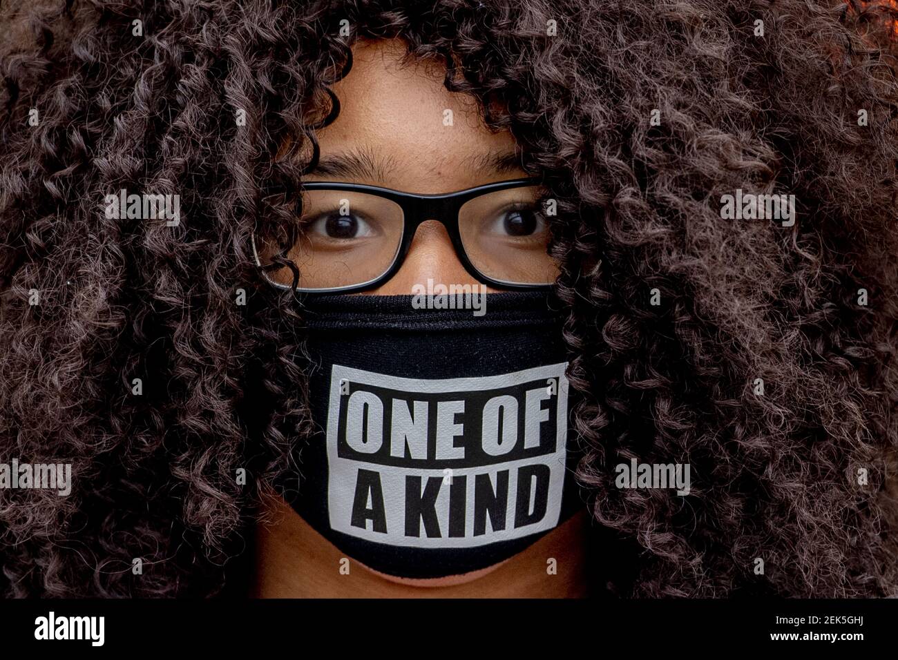 A protester wears a face mask written on One of a kind during the ...