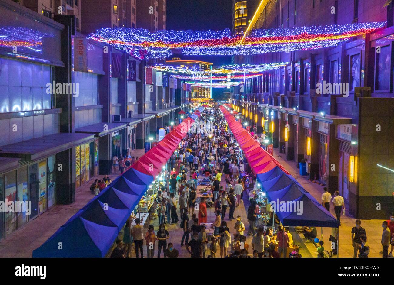 Aerial view of a night market decorated with colorful LED lights that ...