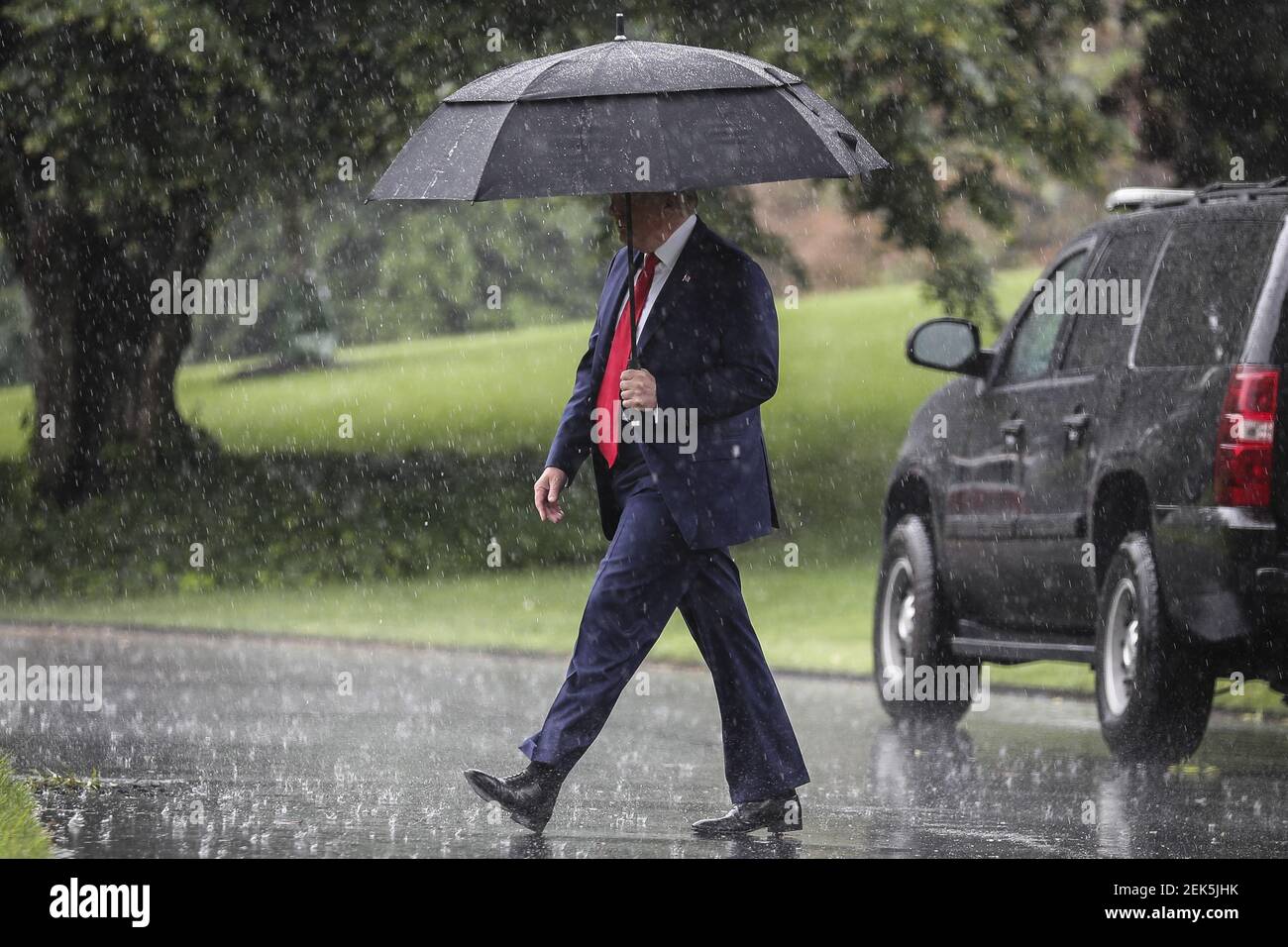 President Donald Trump walks on the South Lawn of the White House in a ...