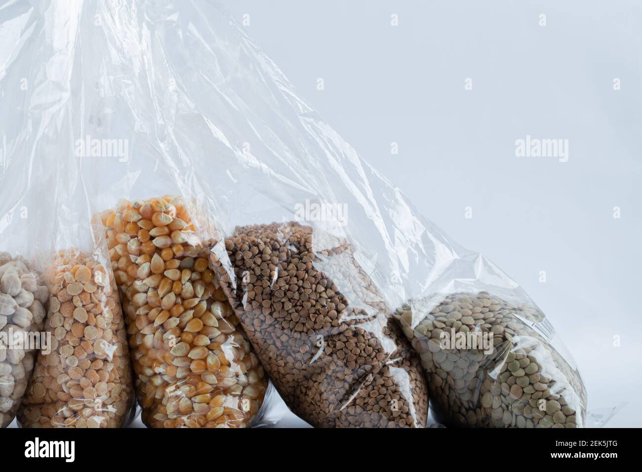 Different kinds of beans packed on a gray background Stock Photo - Alamy