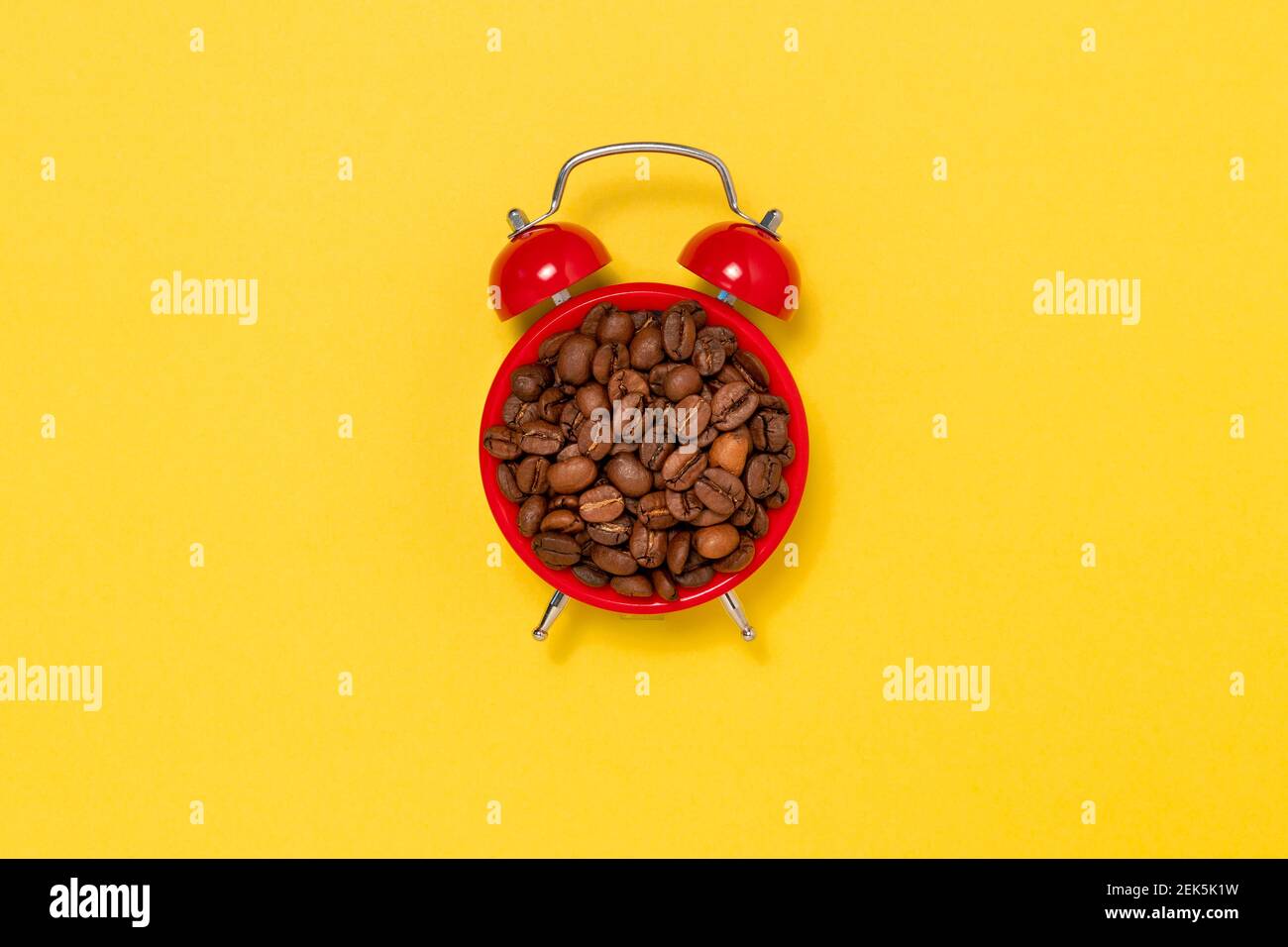 Morning coffee and alarm clock concept. Coffee beans on alarm clock ...