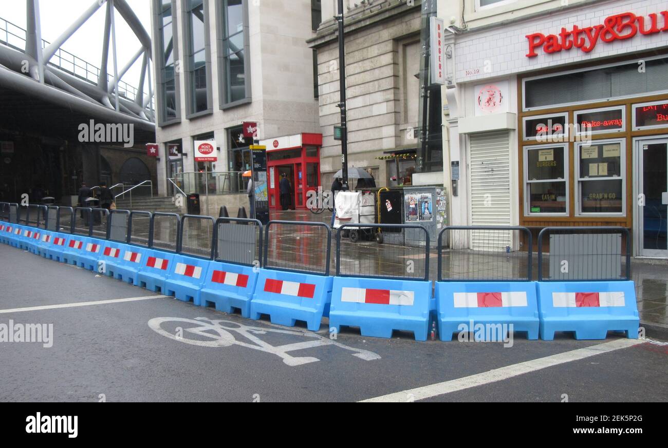 Blue barriers extend out into the road near London Bridge to extend the ...