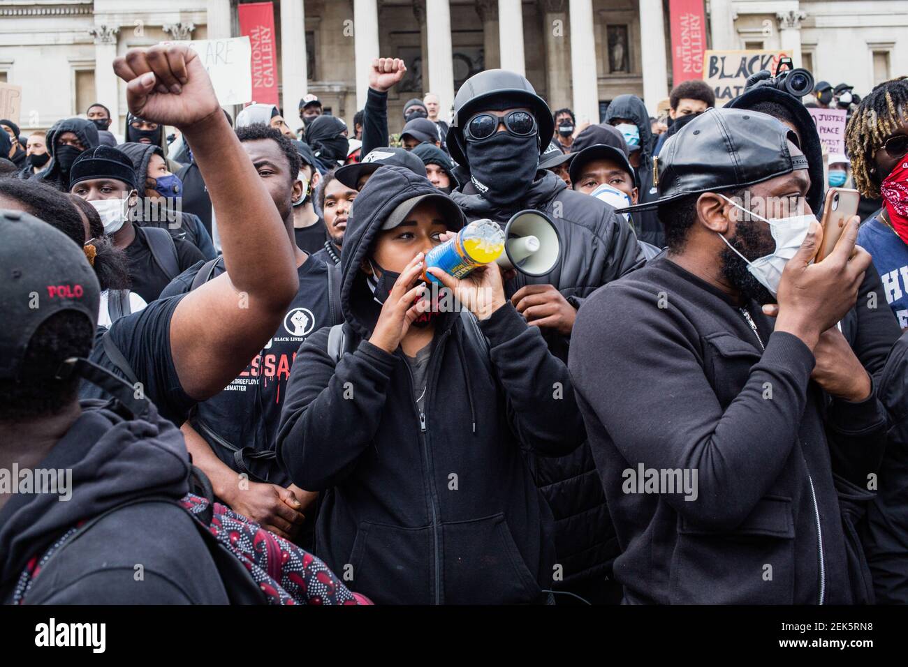 Protesters hold up their fists during the demonstration. The death of ...