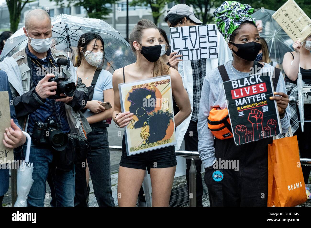 Protesters pose with BLM placards during the demonstration. A large ...