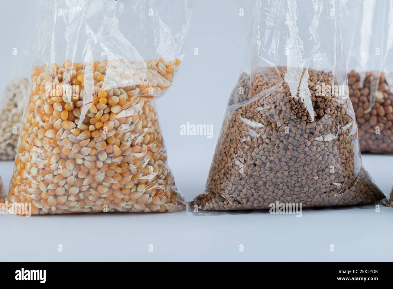 Different kinds of beans packed on a gray background Stock Photo - Alamy