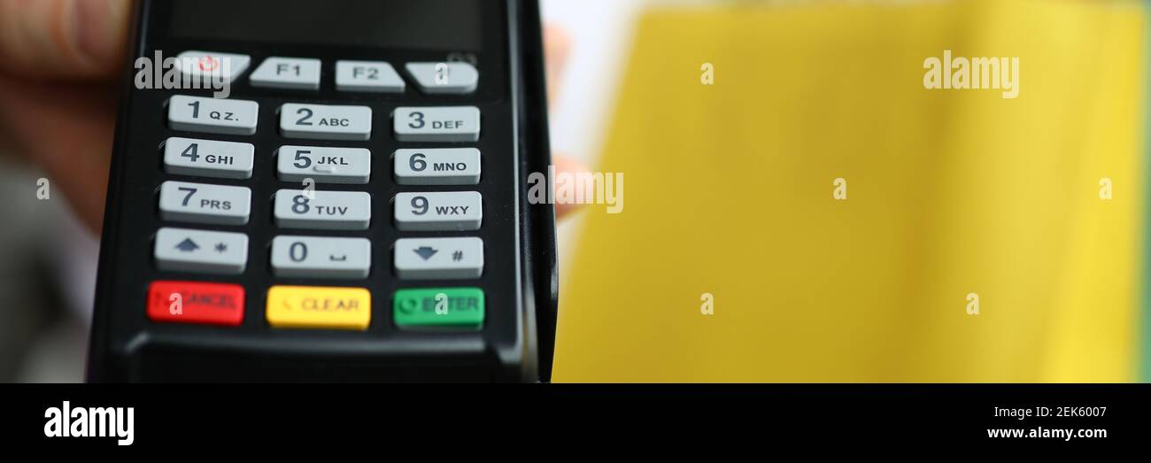 Man hold cash register close up on background of packages with ...