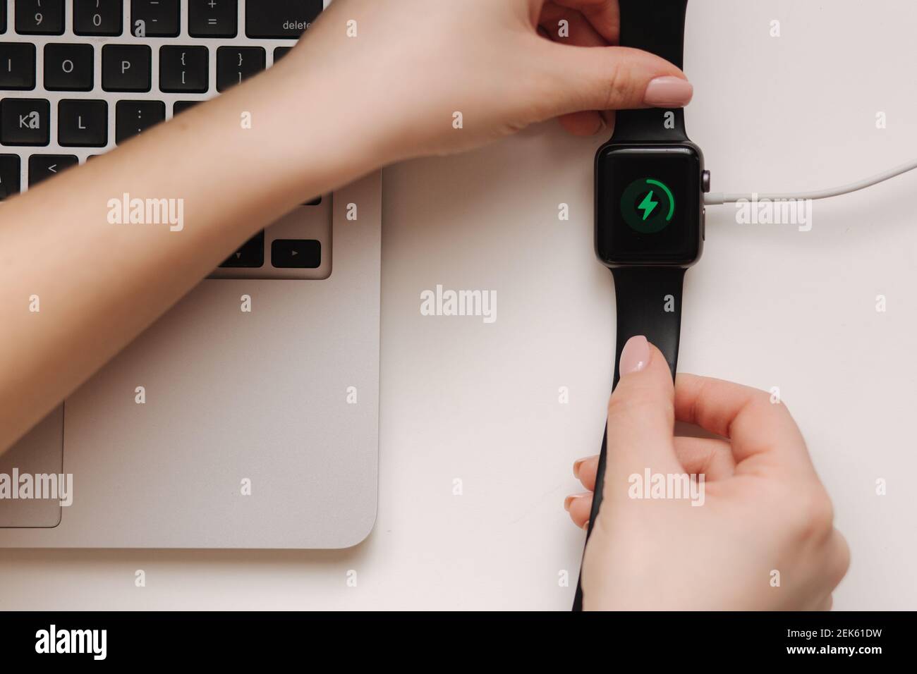 Female hand put smart watch on wireless charging with on-screen ...