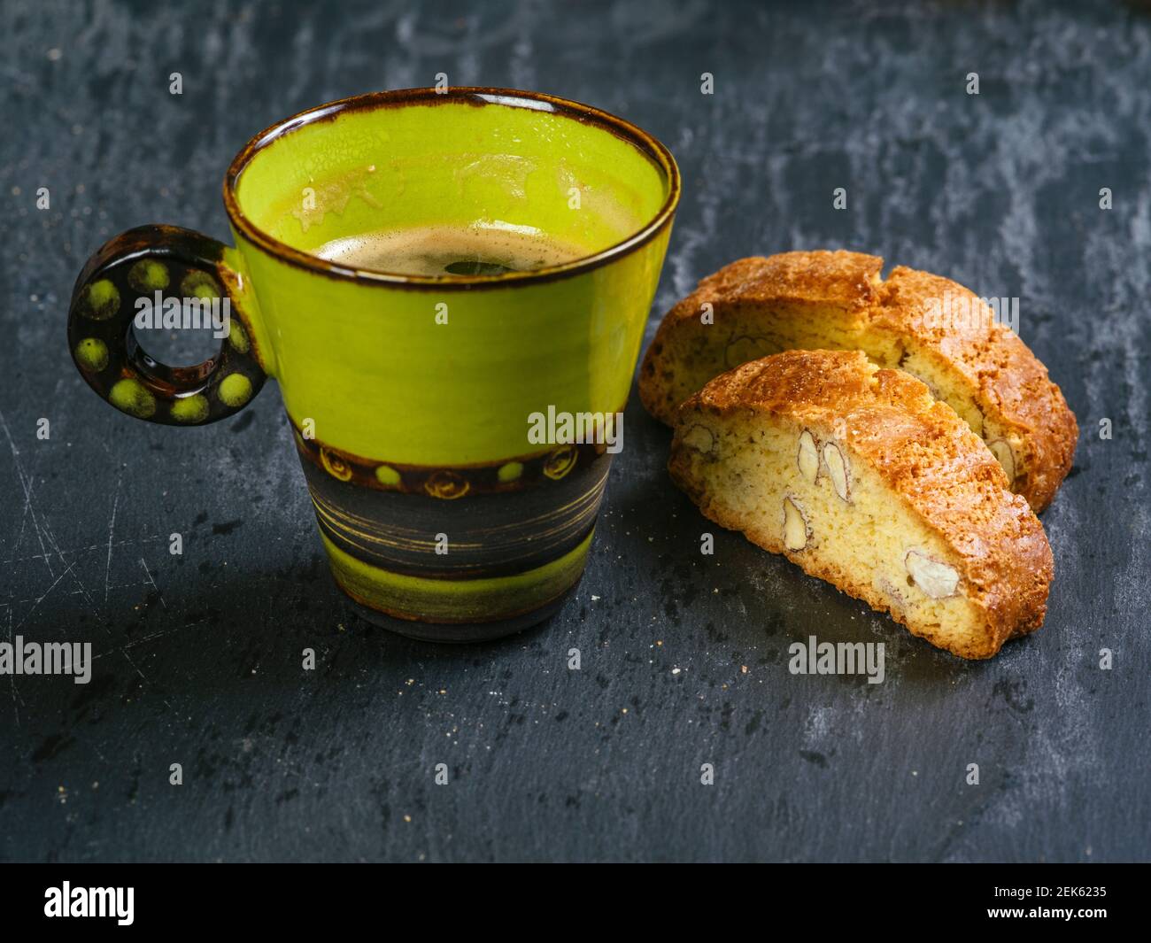 Two Italian biscotti on a slate background with coffee Stock Photo - Alamy