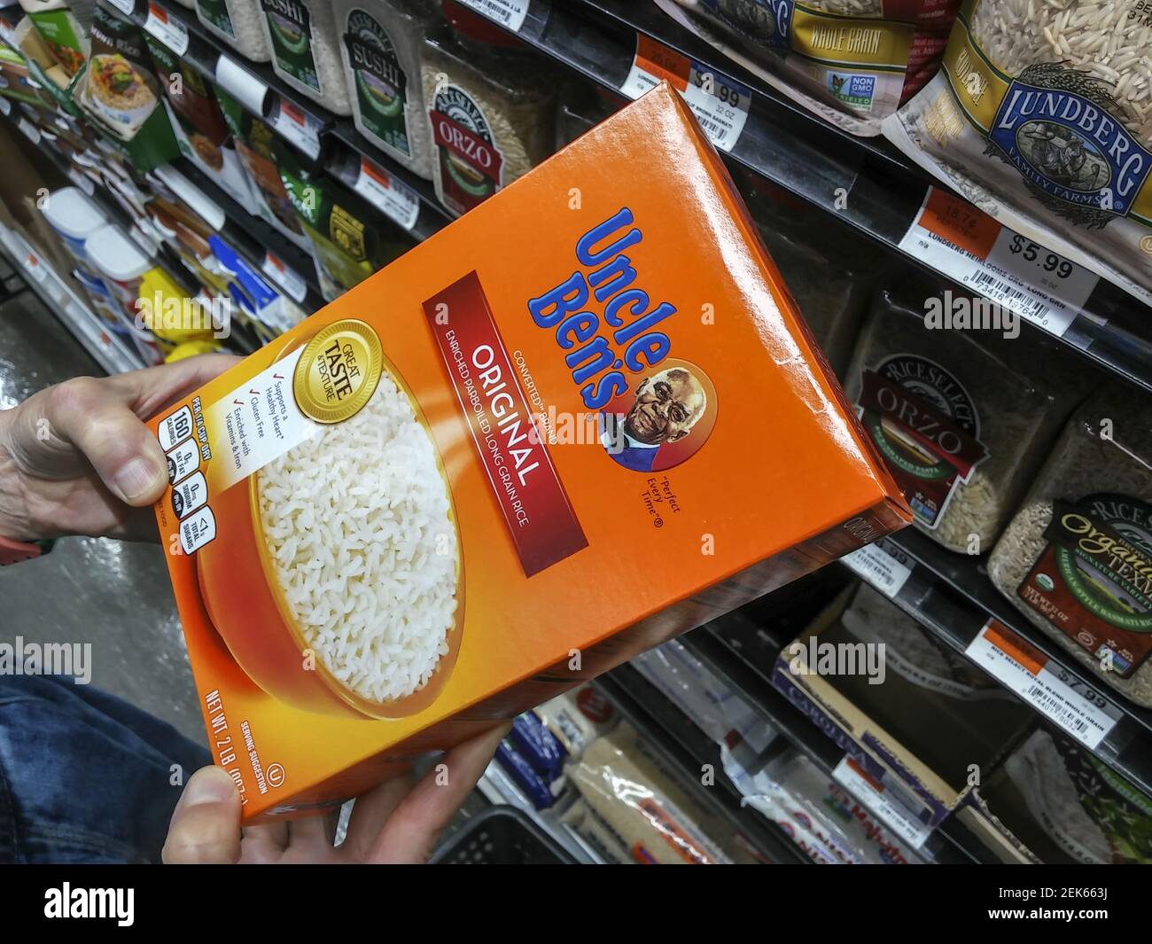 A shopper chooses a box of Marsâ€™ Uncle Benâ€™s brand rice in a ...
