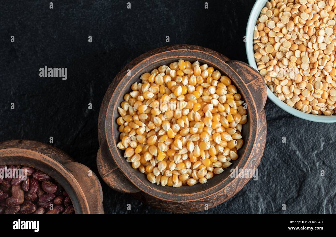 Different kinds of uncooked beans on ancient pots Stock Photo - Alamy
