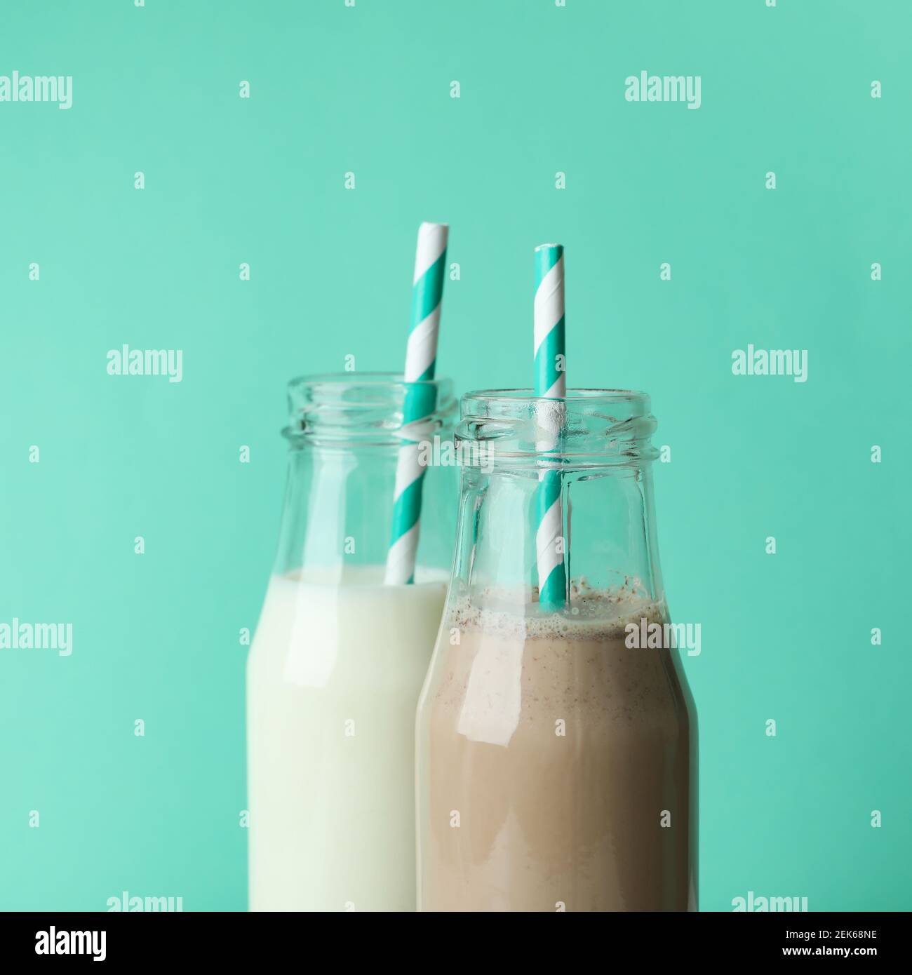 Bottles with milk and milkshake on mint background Stock Photo - Alamy