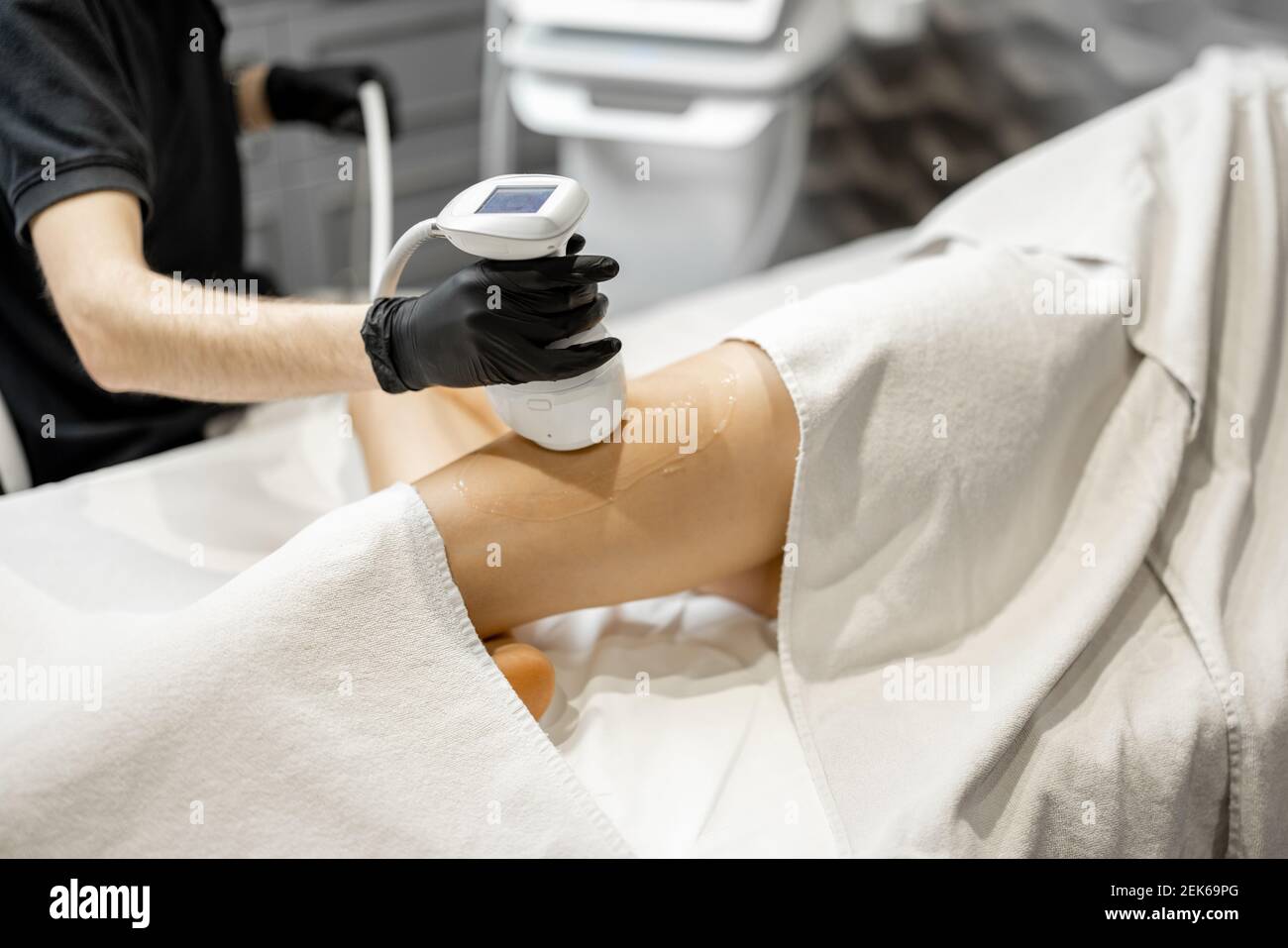 Doctor doing ultrasound liposuction procedure in medical clinic Stock ...