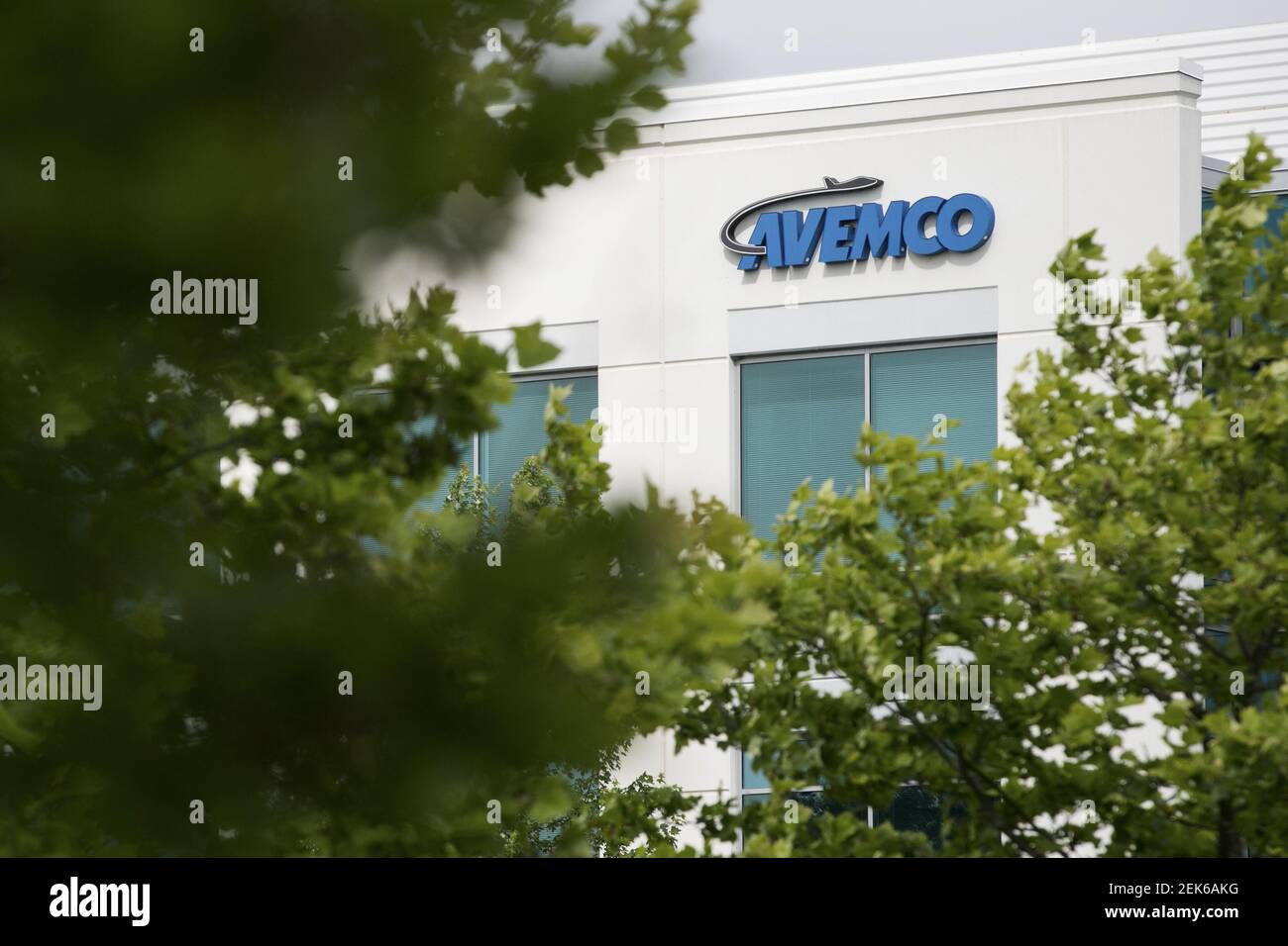 A logo sign outside of the headquarters of Avemco in Frederick ...