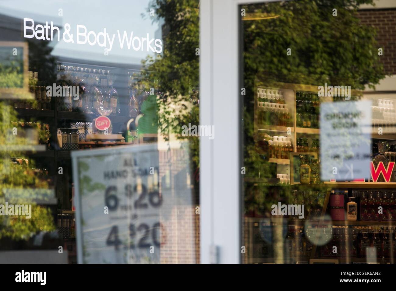 A logo sign outside of a Bath & Body Works retail store location in ...