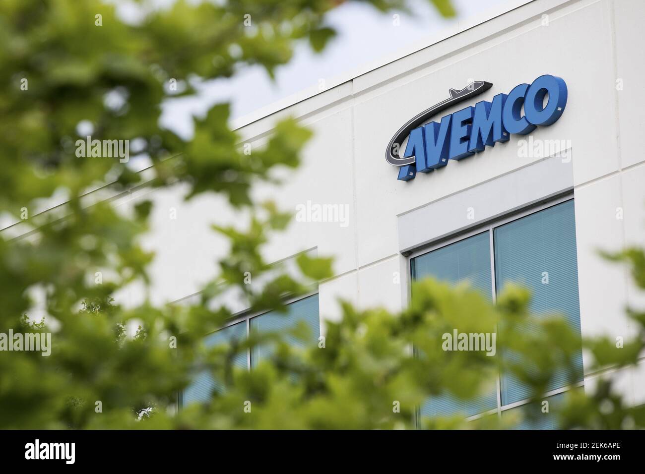 A logo sign outside of the headquarters of Avemco in Frederick ...