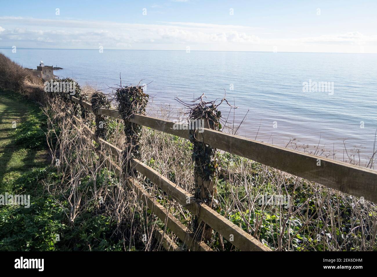 Fencing along a cliff top at Sidmouth, Devon to keep people away from ...