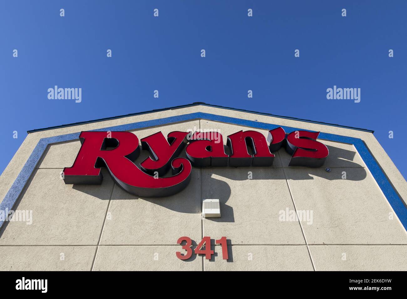 A logo sign outside of a closed and abandoned Ryan's Buffet restaurant ...
