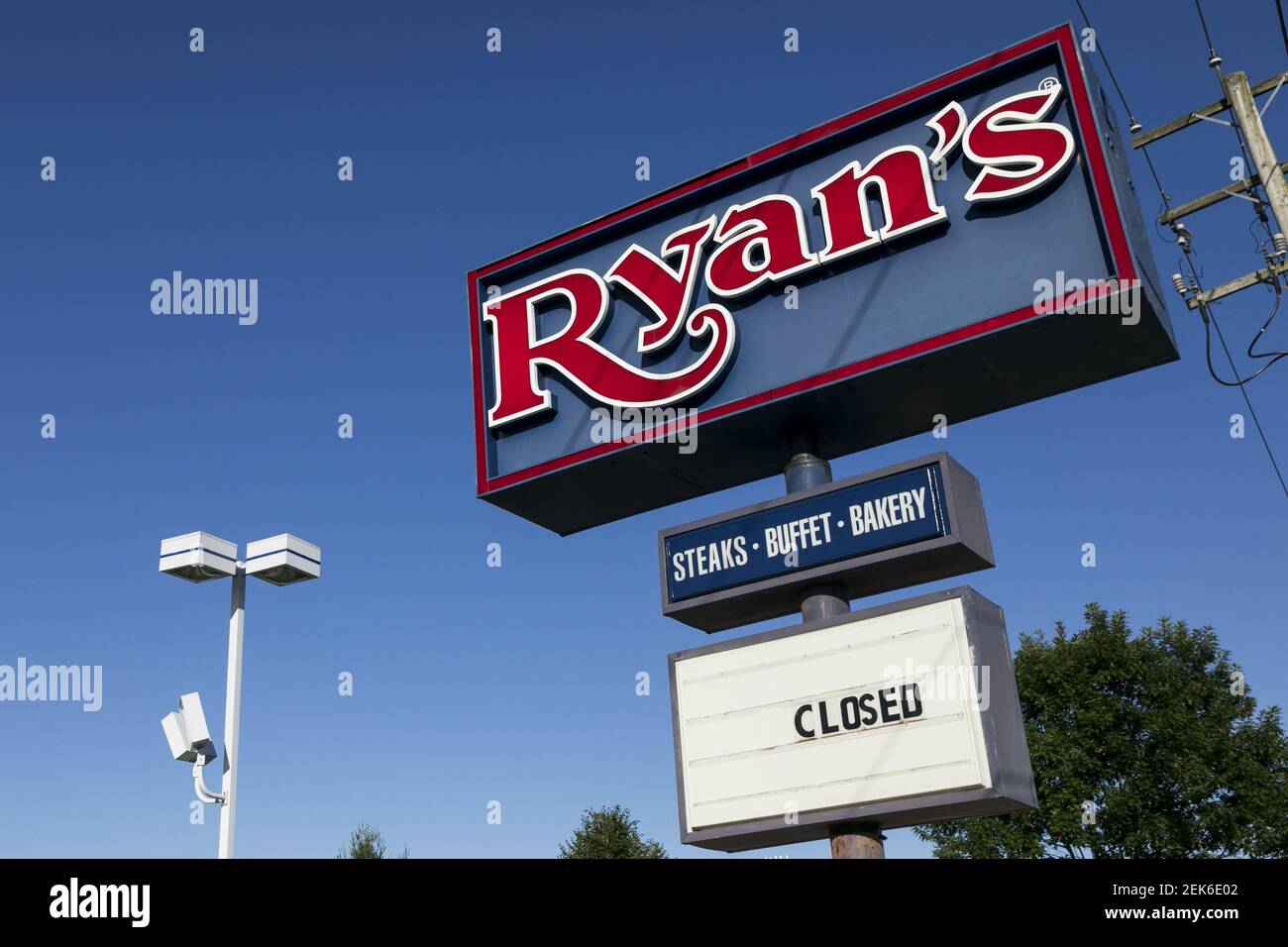 A logo sign outside of a closed and abandoned Ryan's Buffet restaurant ...