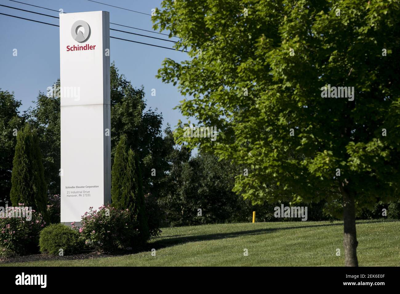 A logo sign outside of a facility occupied by Schindler Elevator ...