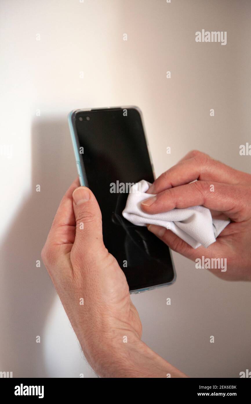 Man Cleaning Mobile Phone with Cloth Stock Photo - Alamy
