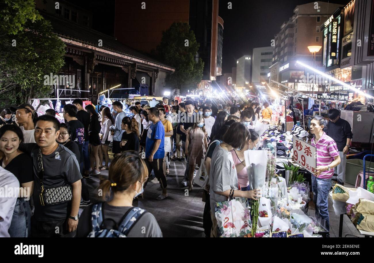 People shop at the night market on Huaihe Road in Hefei city, east ...