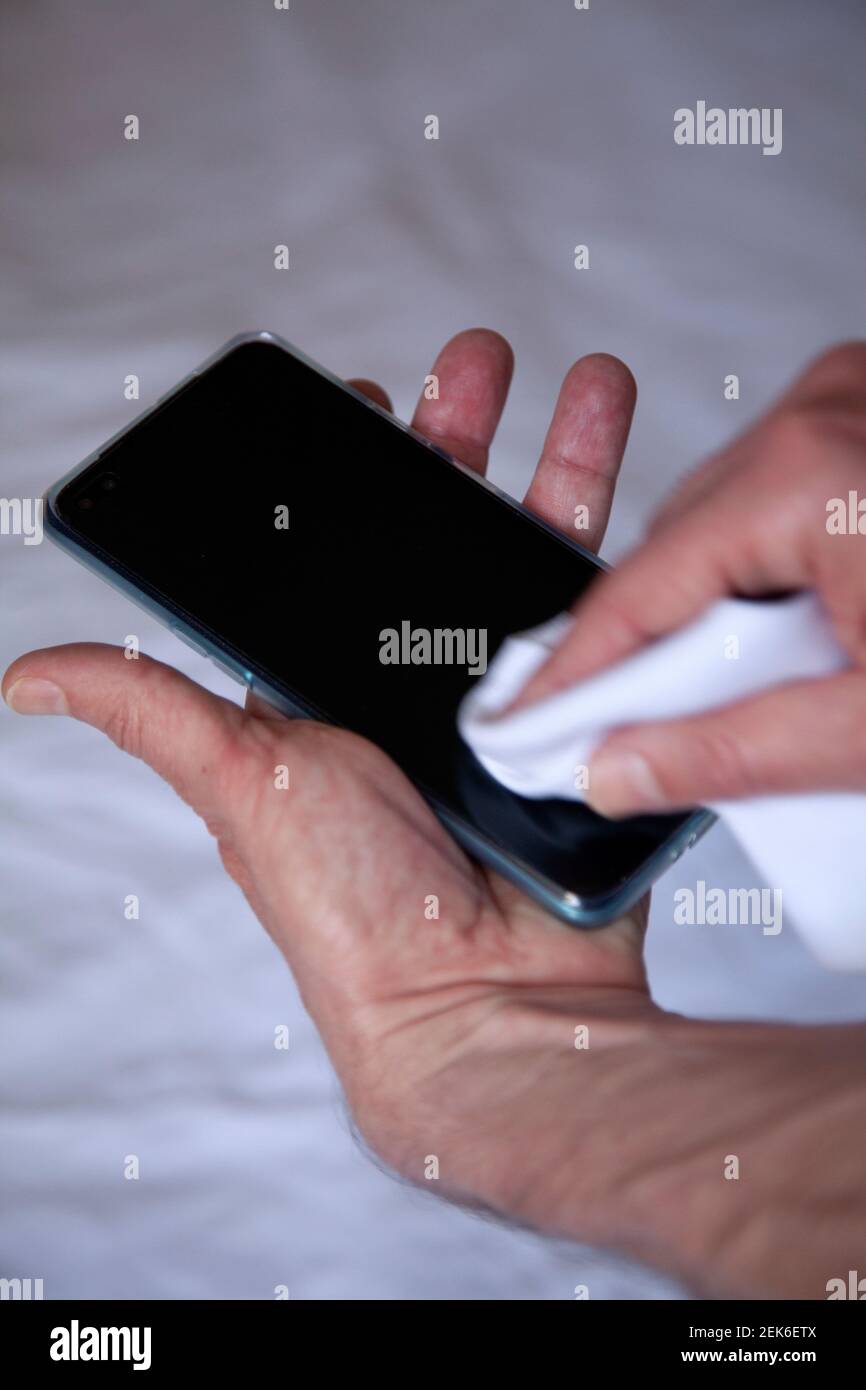Man Cleaning Mobile Phone with Cloth Stock Photo - Alamy