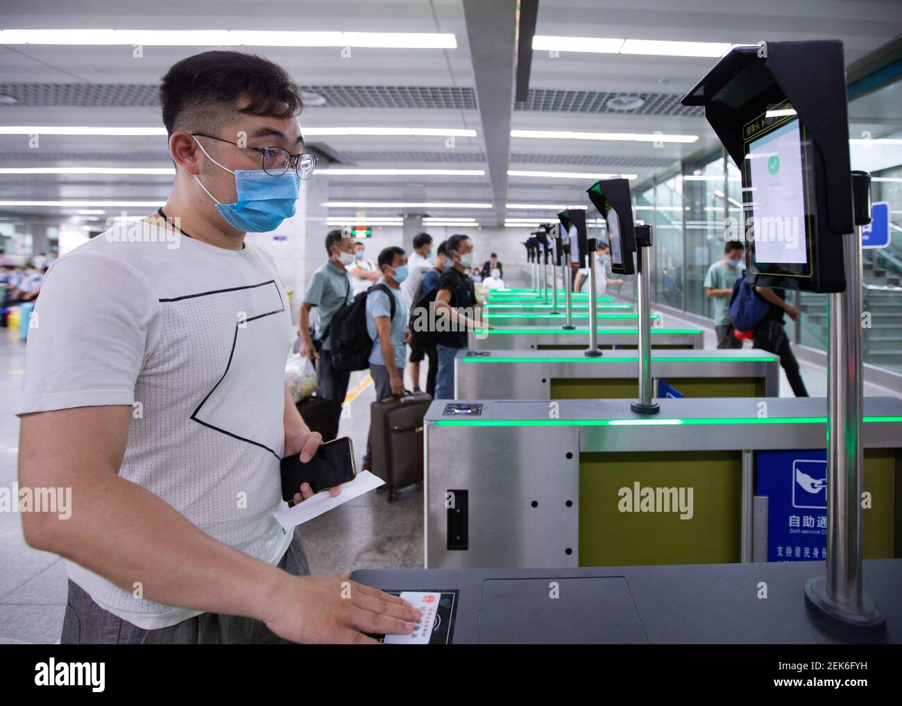 Passengers check in at the gate of the waiting hall of the railway ...