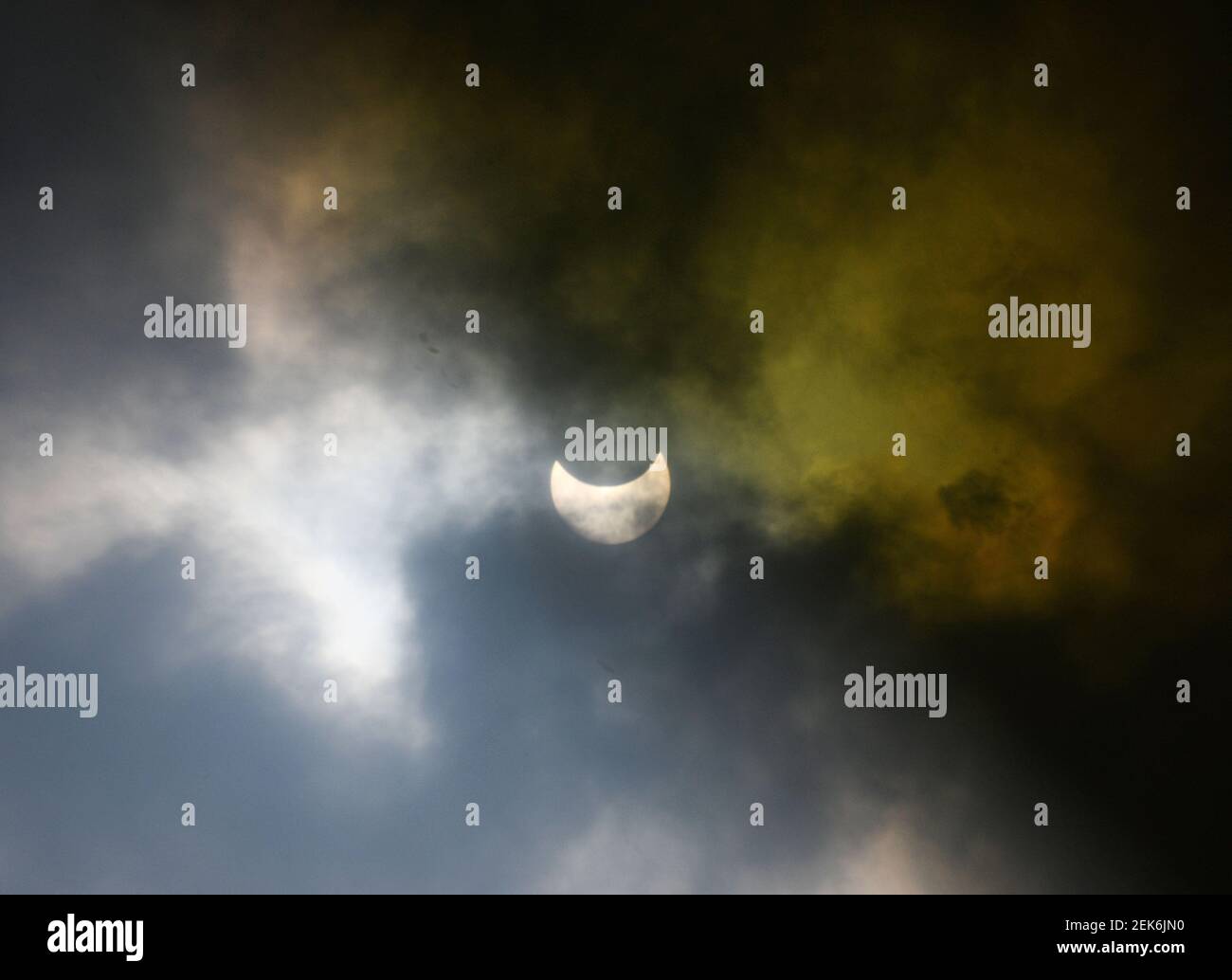 NEW DELHI, INDIA – JUNE 21: A view of the partially eclipsed sun seen ...