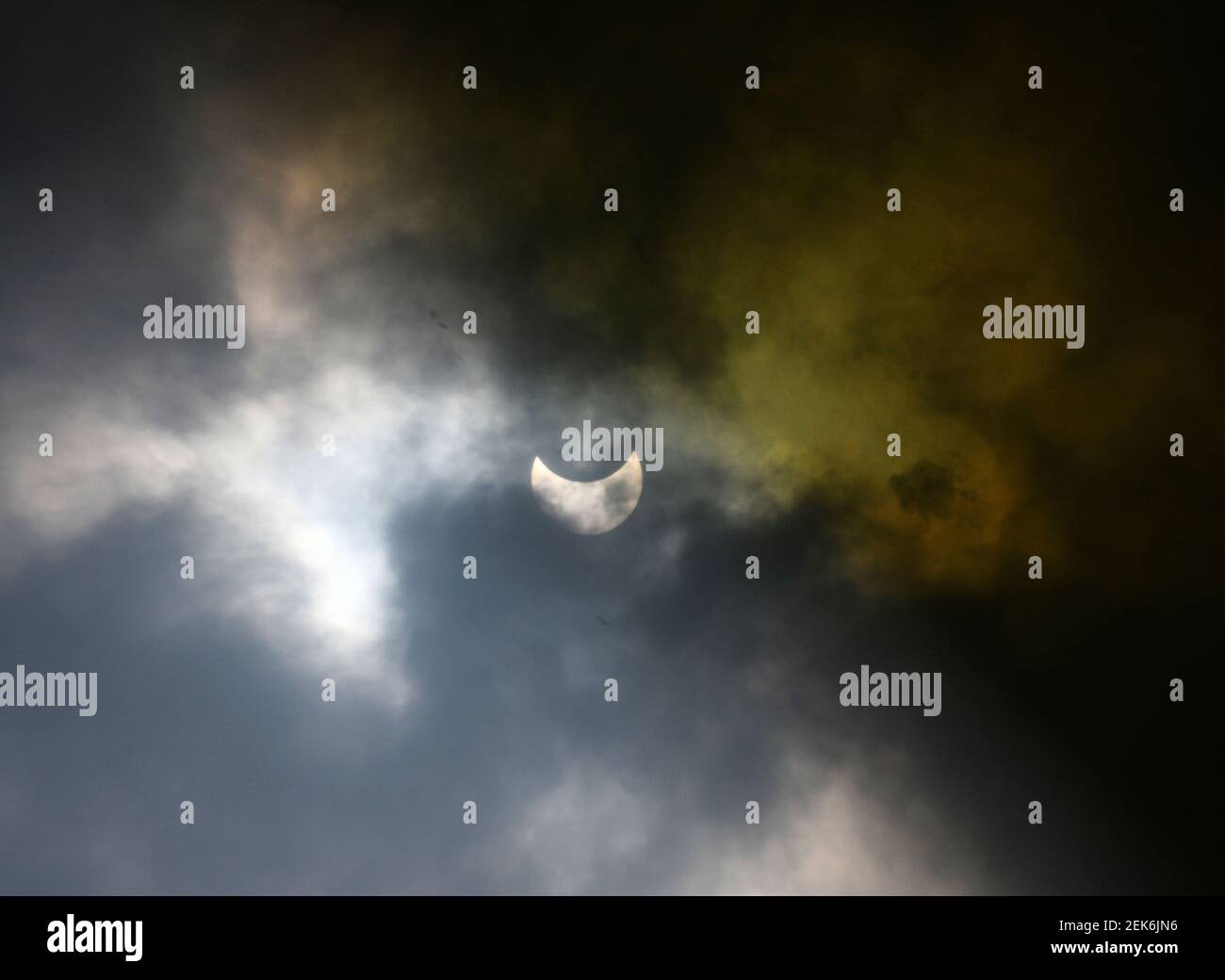 NEW DELHI, INDIA – JUNE 21: A view of the partially eclipsed sun seen ...