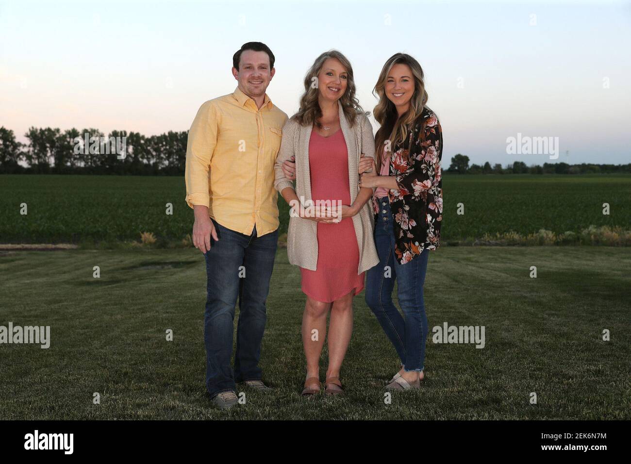 Julie Loving, center, poses for photographs with her son-in-law, Aaron ...