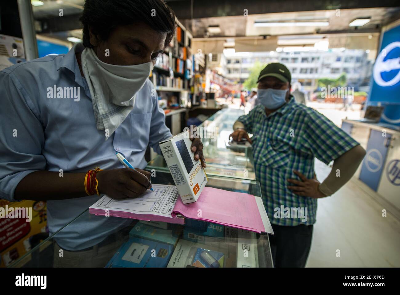 A customer purchases made in China items while the shopkeeper makes the ...