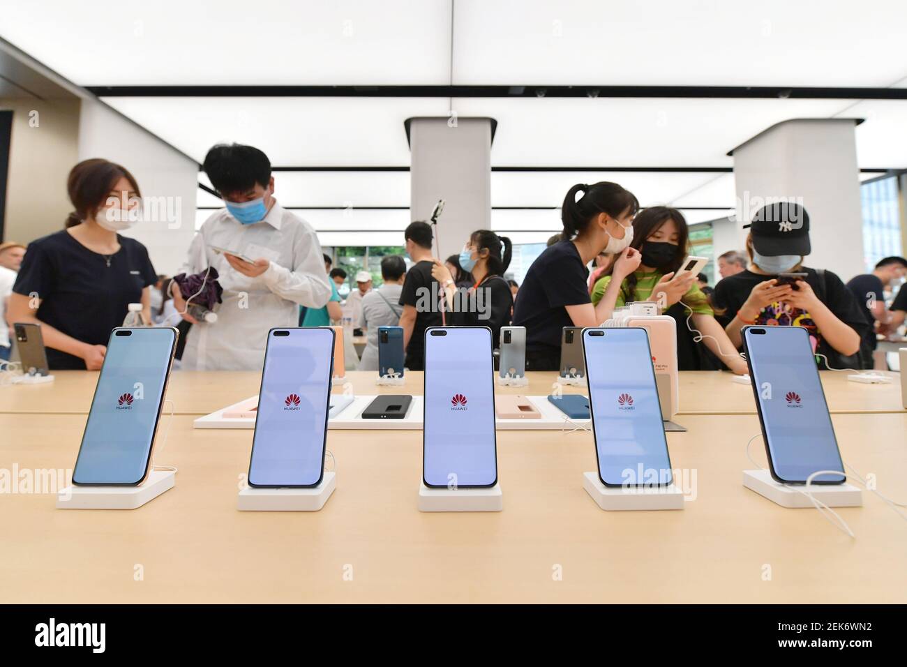 Citizens queue in front Huawei Technologies' biggest flagship store ...